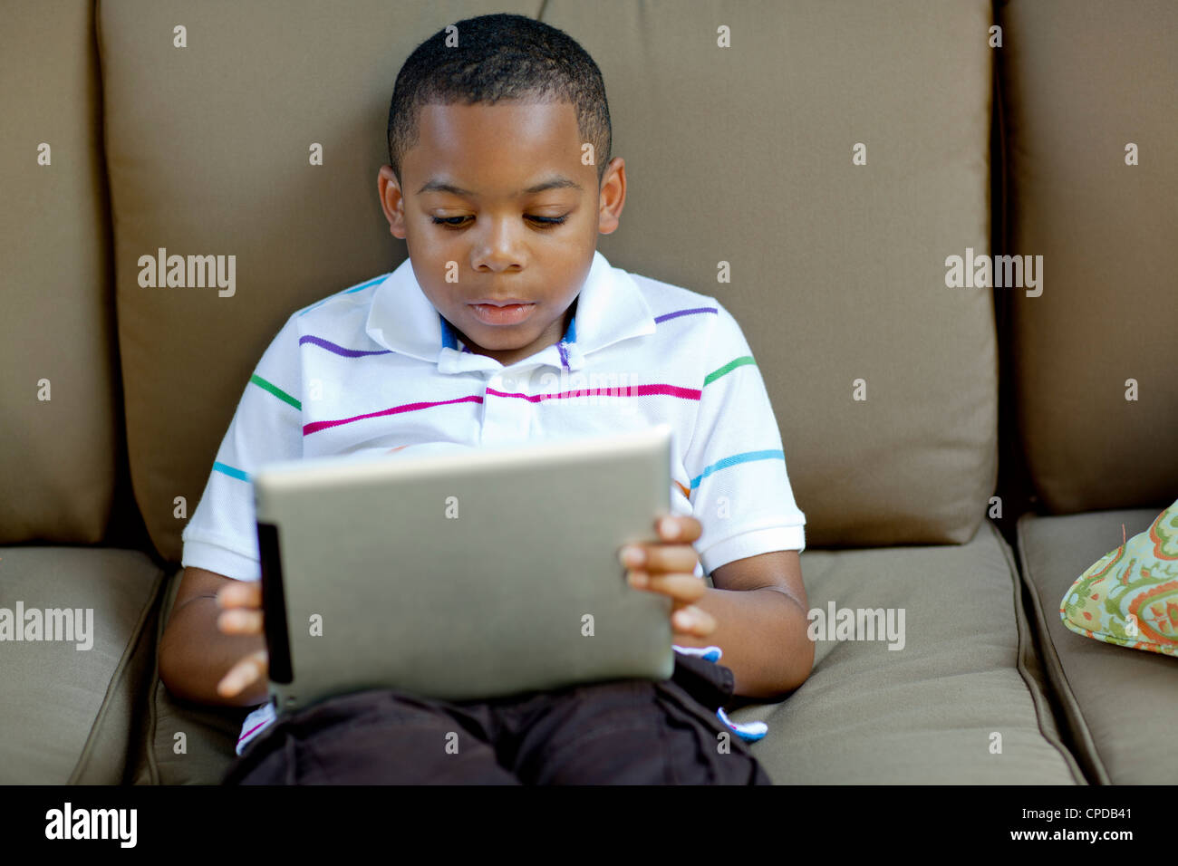 African American boy using digital tablet Stock Photo - Alamy