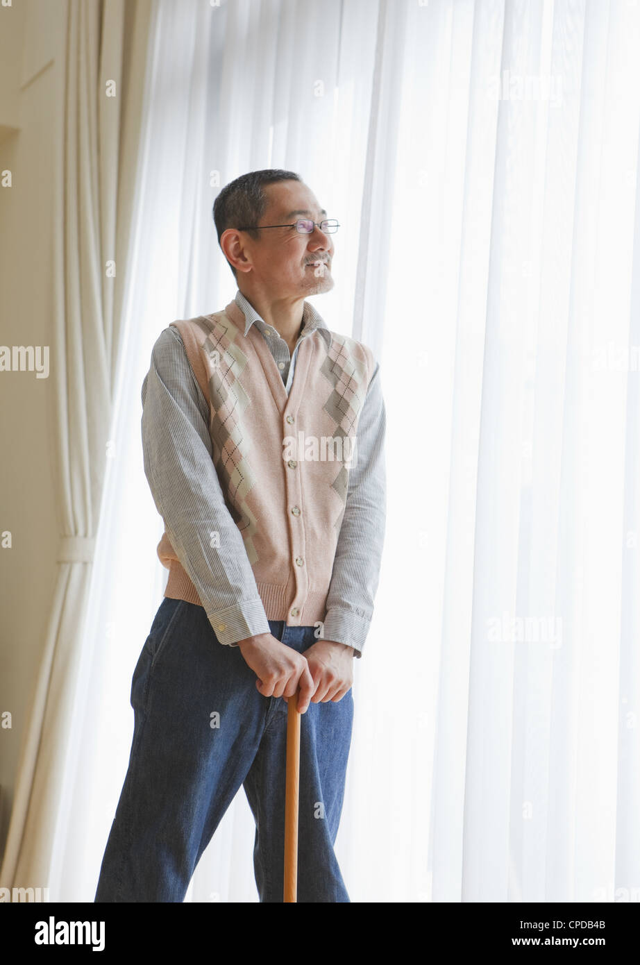Senior man using a stick Stock Photo - Alamy