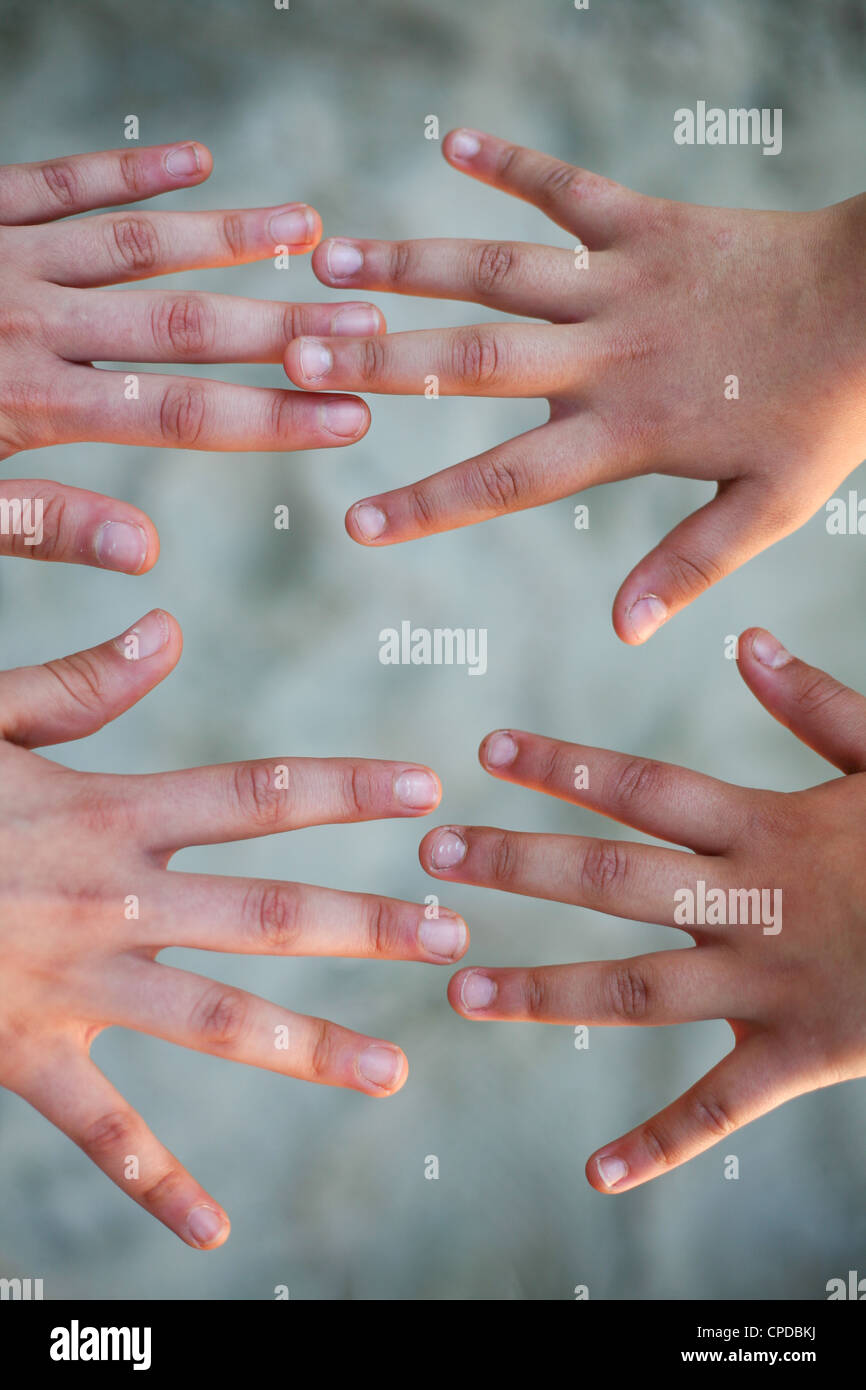 Two pairs of ethnic children's hands over a neutral background Stock ...