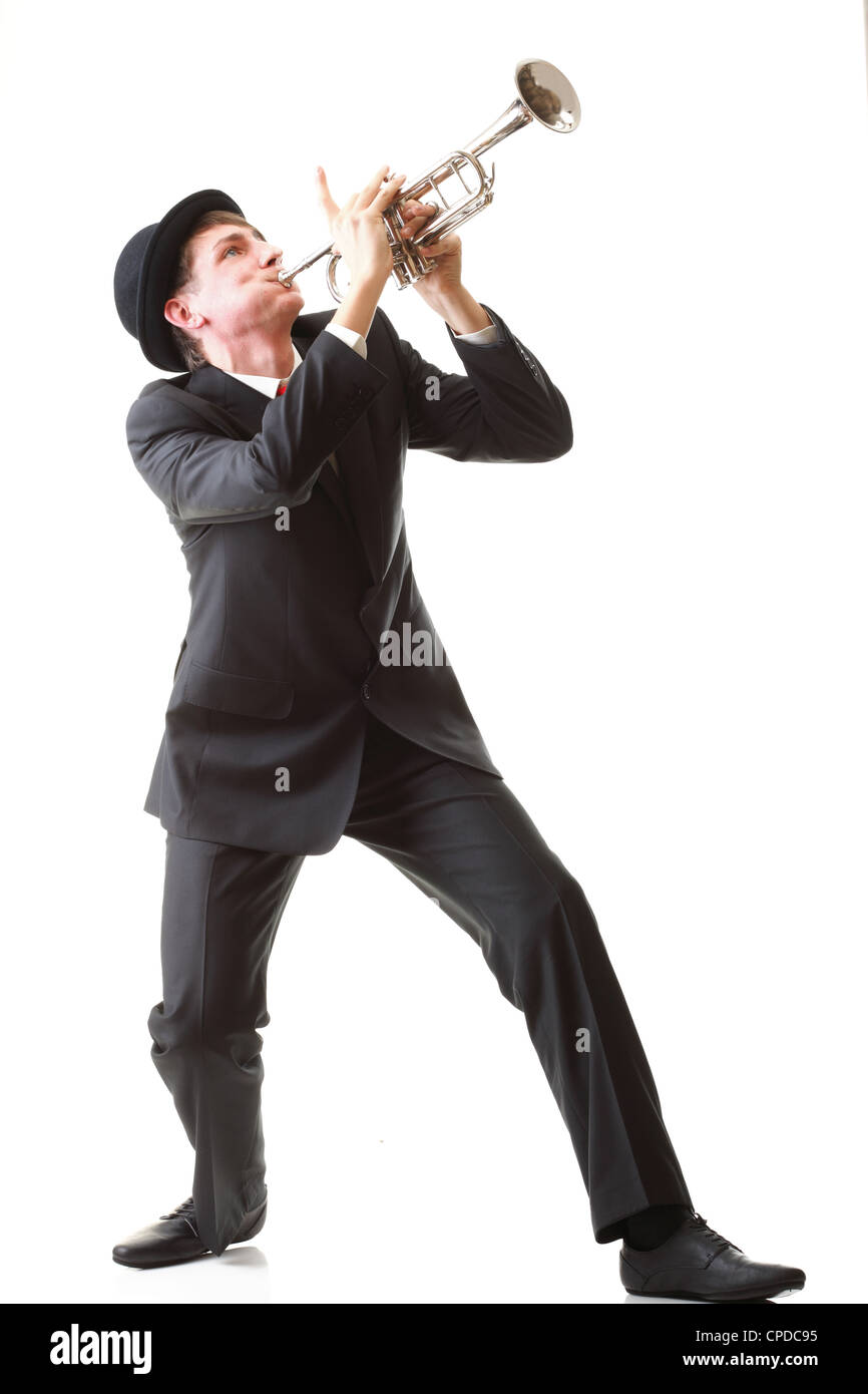 Portrait of a young man playing his Trumpet plays isolated white ...
