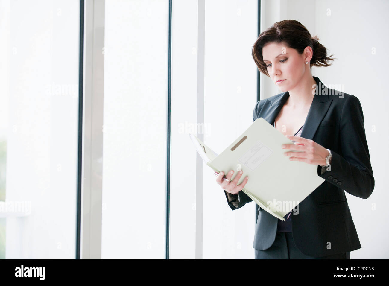 Cuban businesswoman looking at report Stock Photo - Alamy