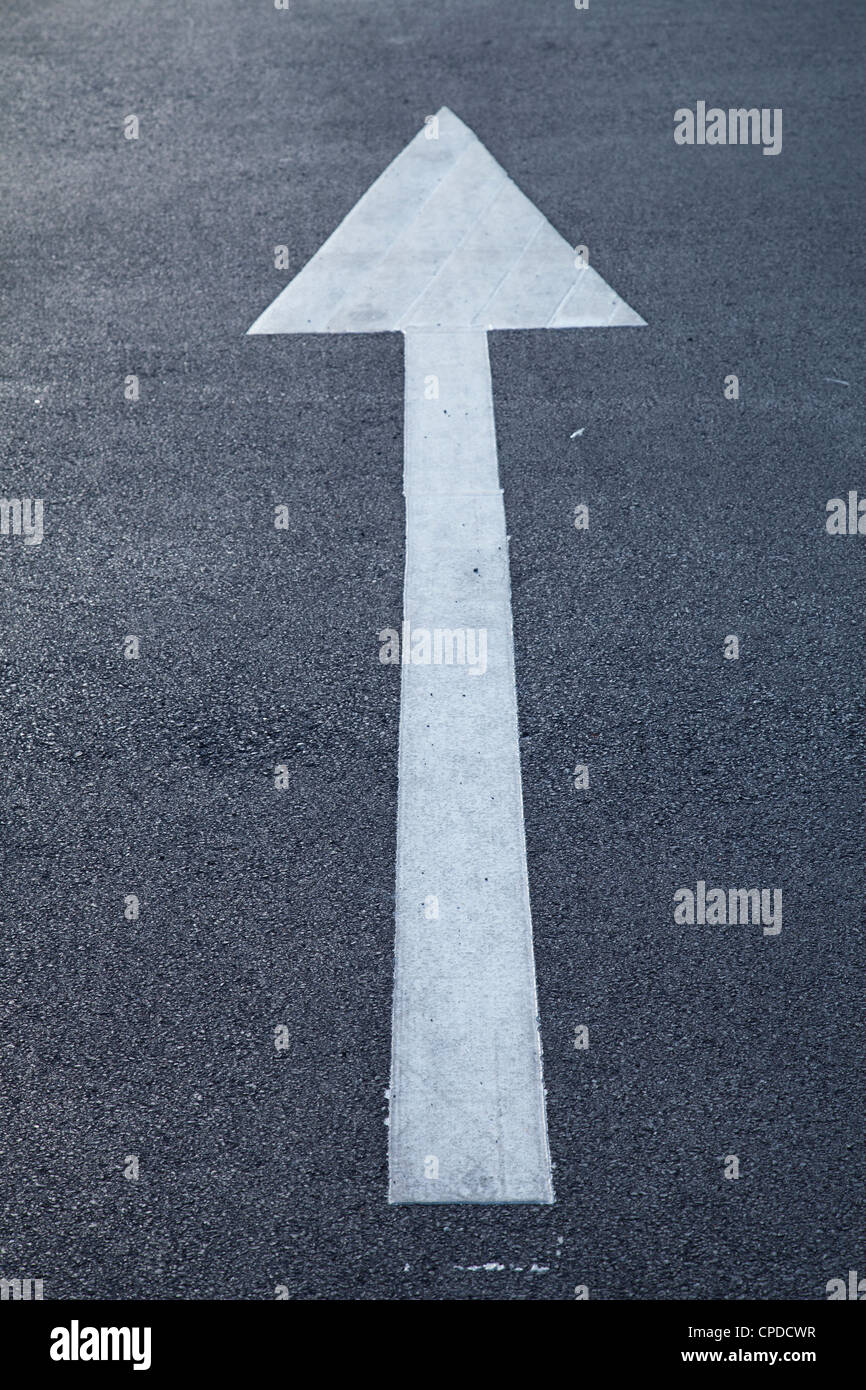 White arrow on Surface traffic Stock Photo - Alamy