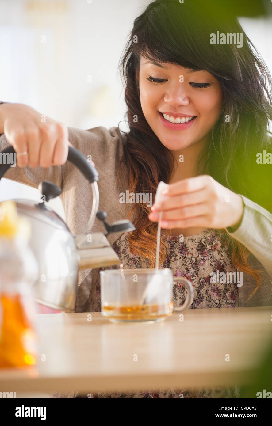 Pacific Islander woman making hot tea Stock Photo - Alamy