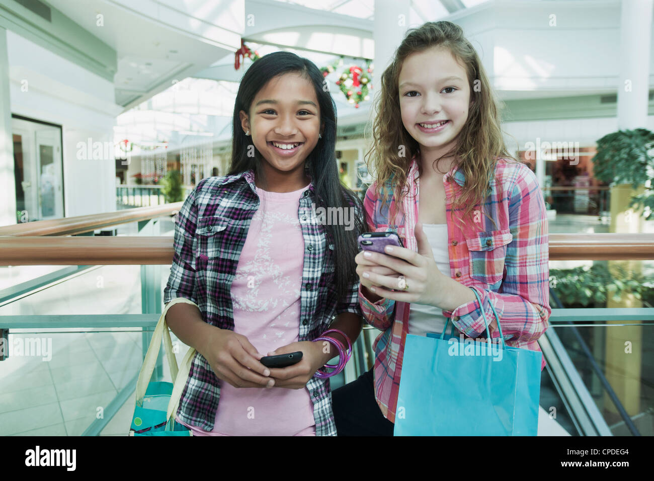 Happy girls out shopping at the mall hi-res stock photography and ...