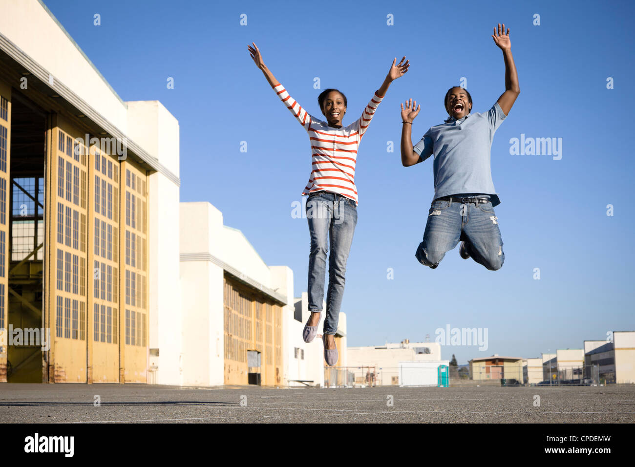 Black couple cheering and jumping Stock Photo - Alamy