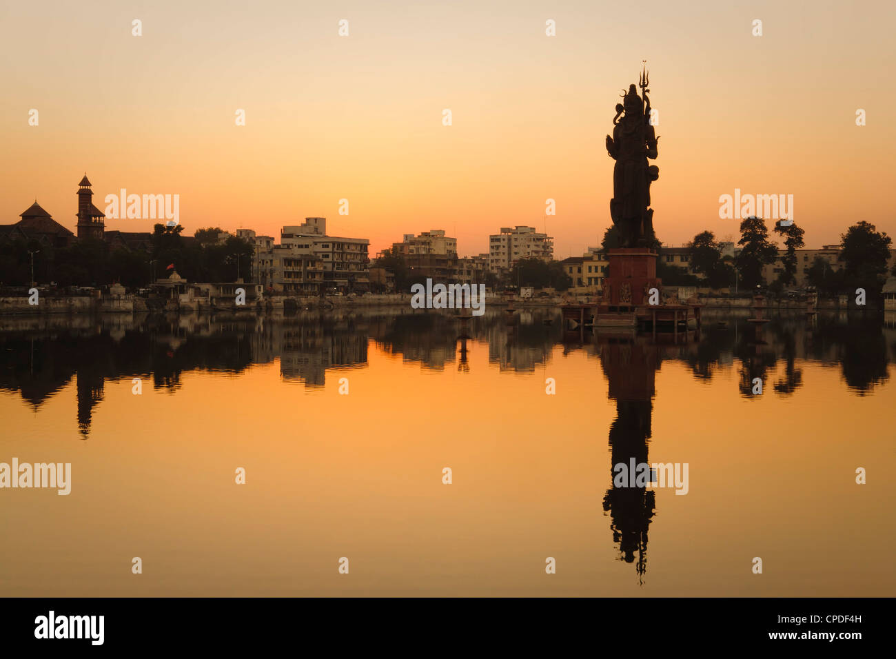Statue of Shiva rising out of a Lake Sur Sagar in the centre of ...