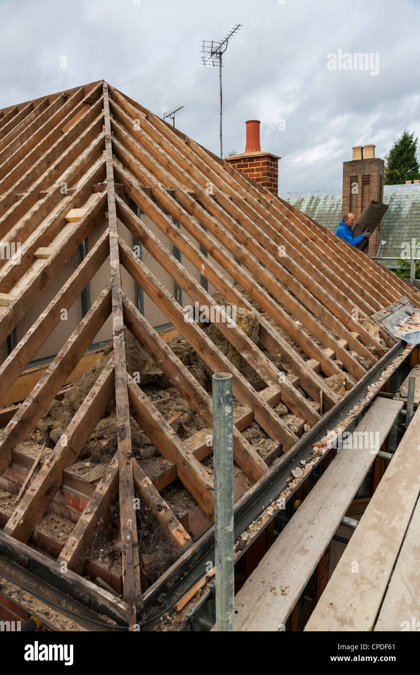 Detached house having tiles striped from roof and replacing with new ...