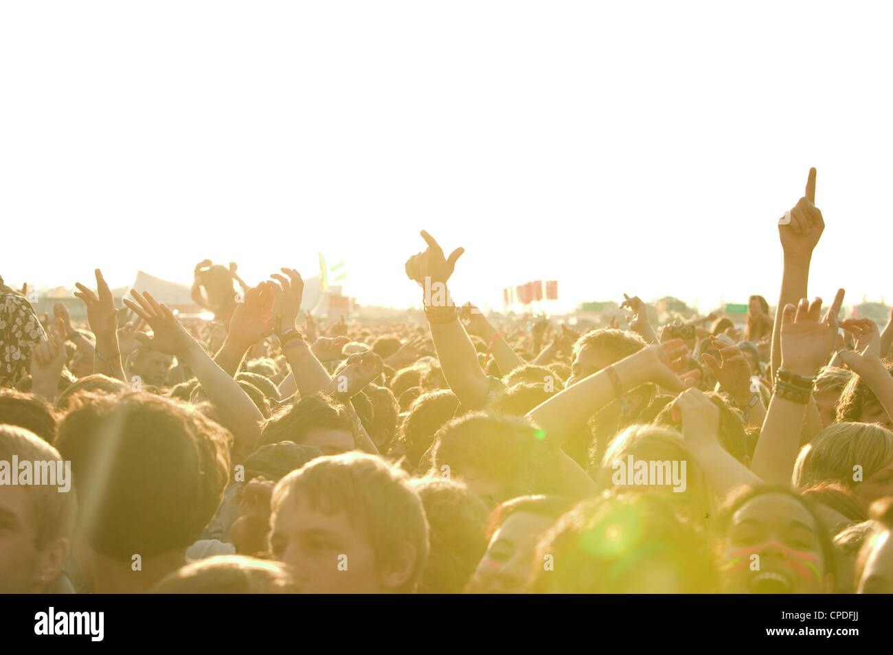 Crowd cheering at a music festival at sunset Stock Photo - Alamy