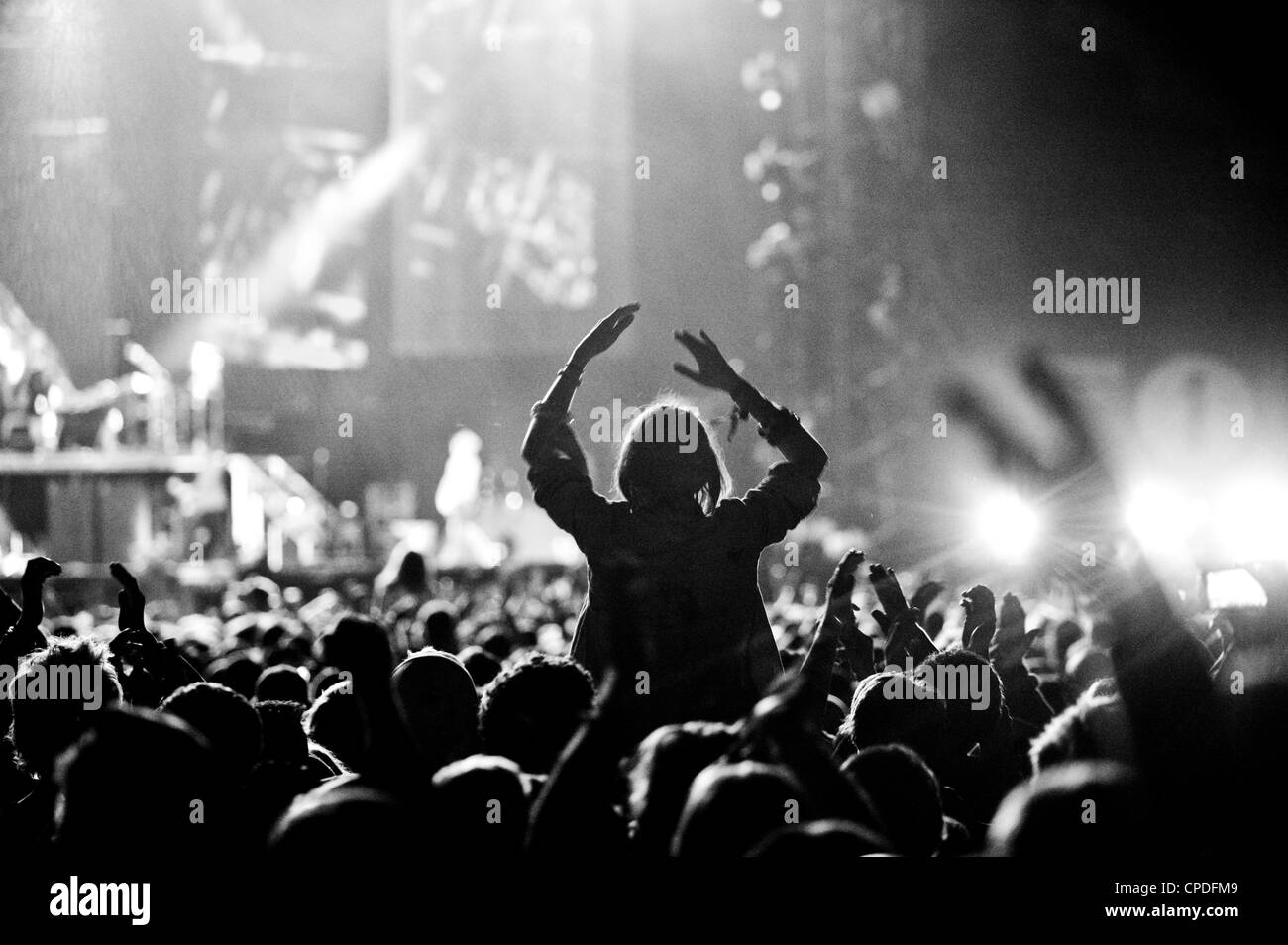 Girl at a music festival on shoulders in the crowd cheering Stock Photo ...