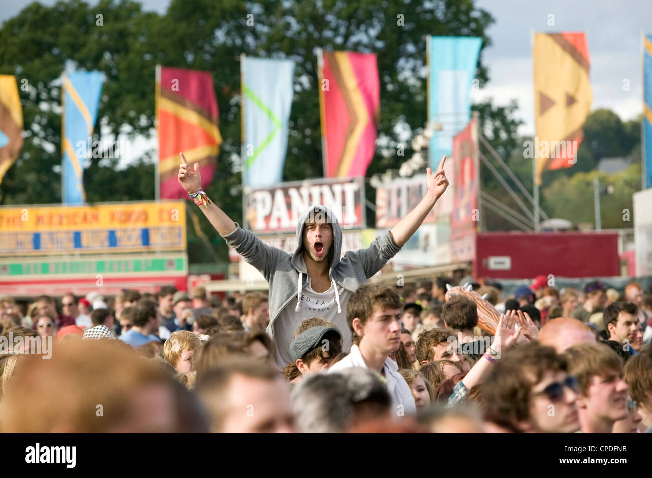 Boy at a music festival on shoulders in the crowd cheering Stock Photo ...