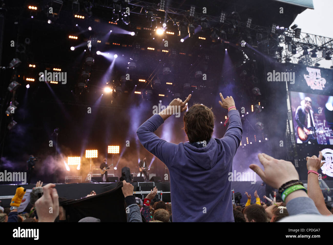 Boy on shoulders cheering in the crowd at gig at a music festival Stock ...