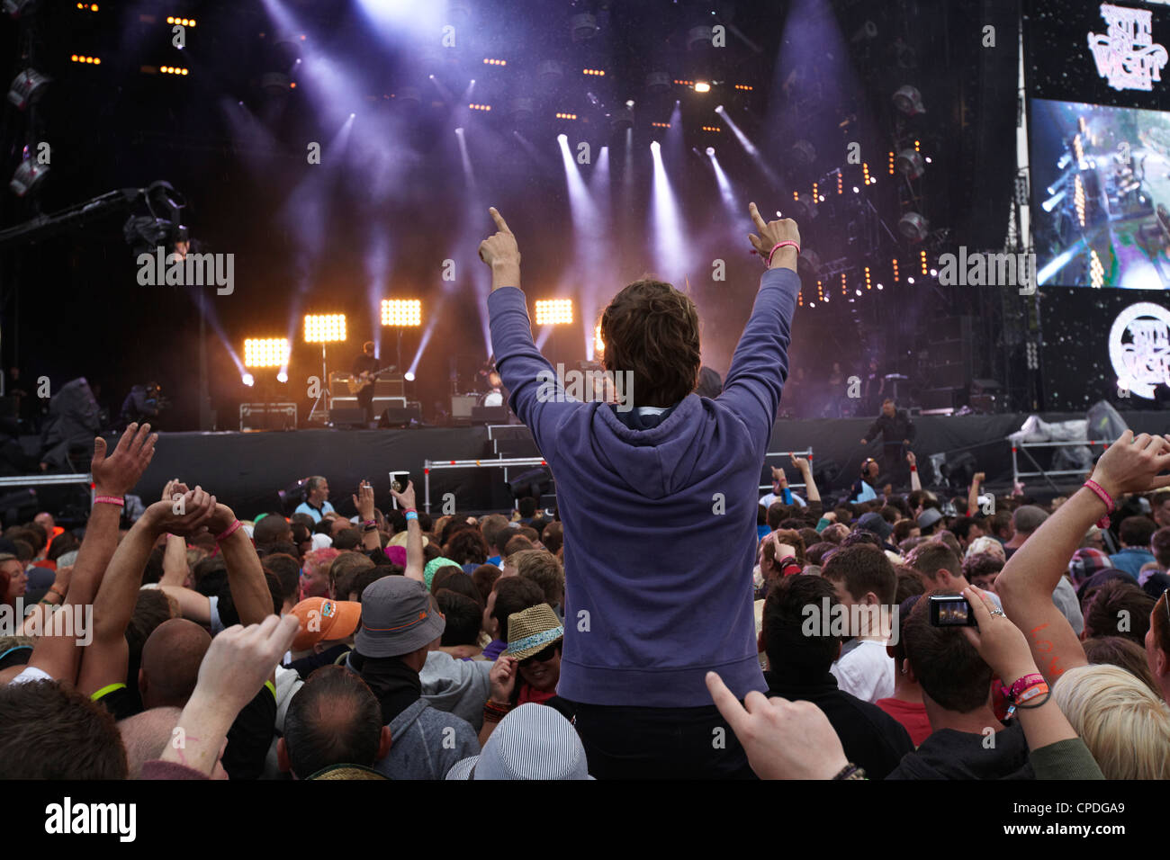 Boy on shoulders cheering in the crowd at gig at a music festival Stock ...