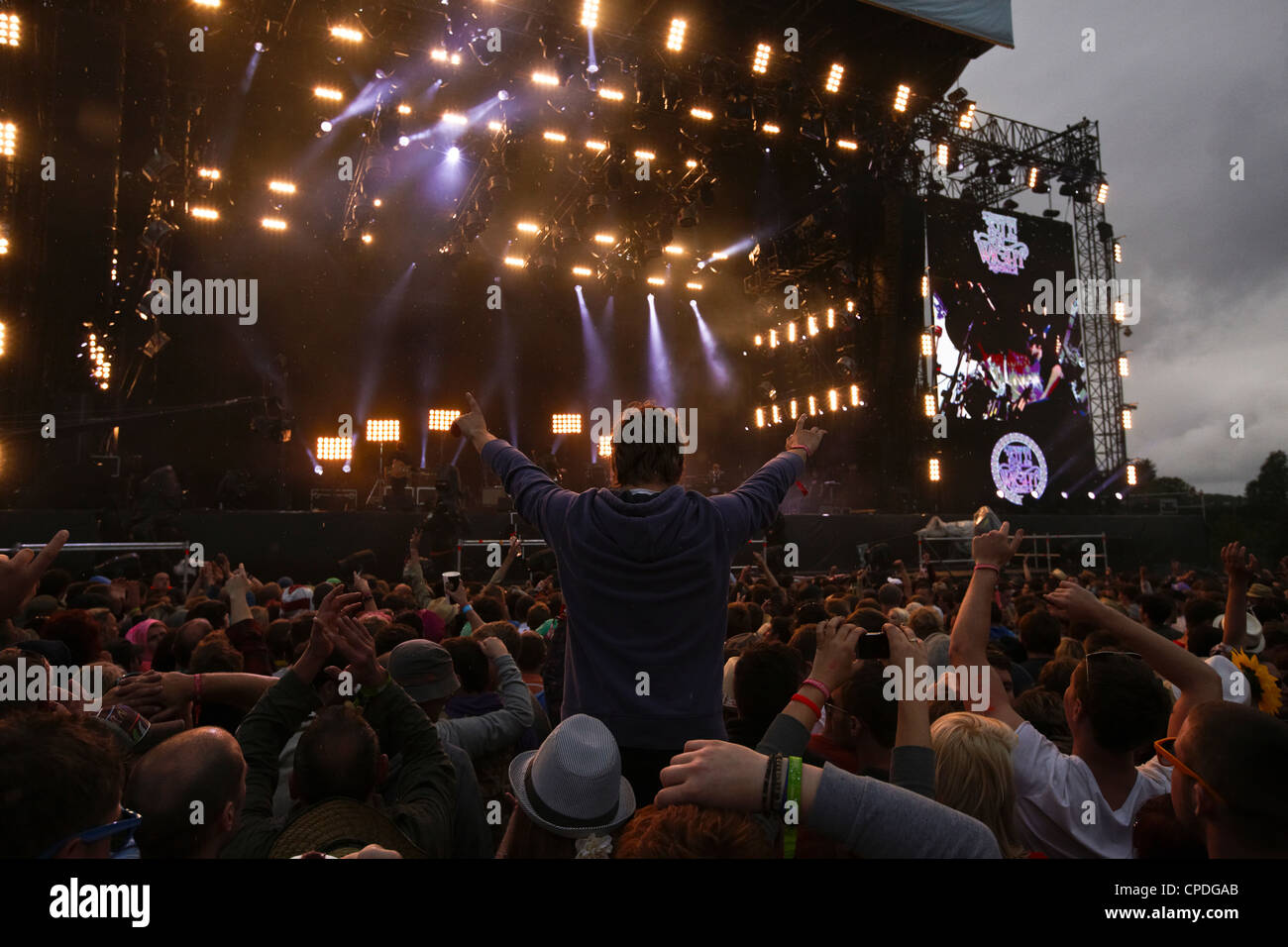 Boy on shoulders cheering in the crowd at gig at a music festival Stock ...