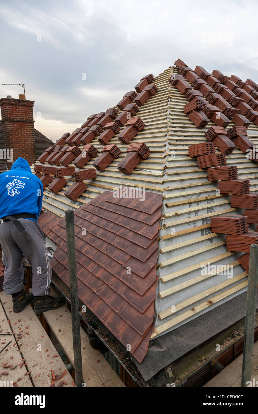 Detached house having tiles striped from roof and replacing with new ...