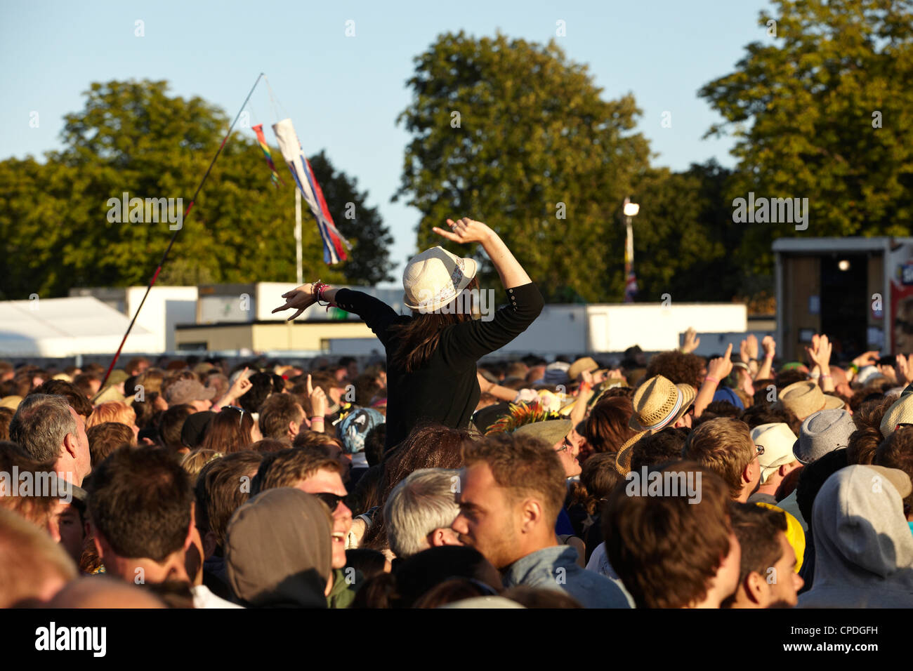 Boy in crowd on shoulders screaming and cheering at a music festival ...