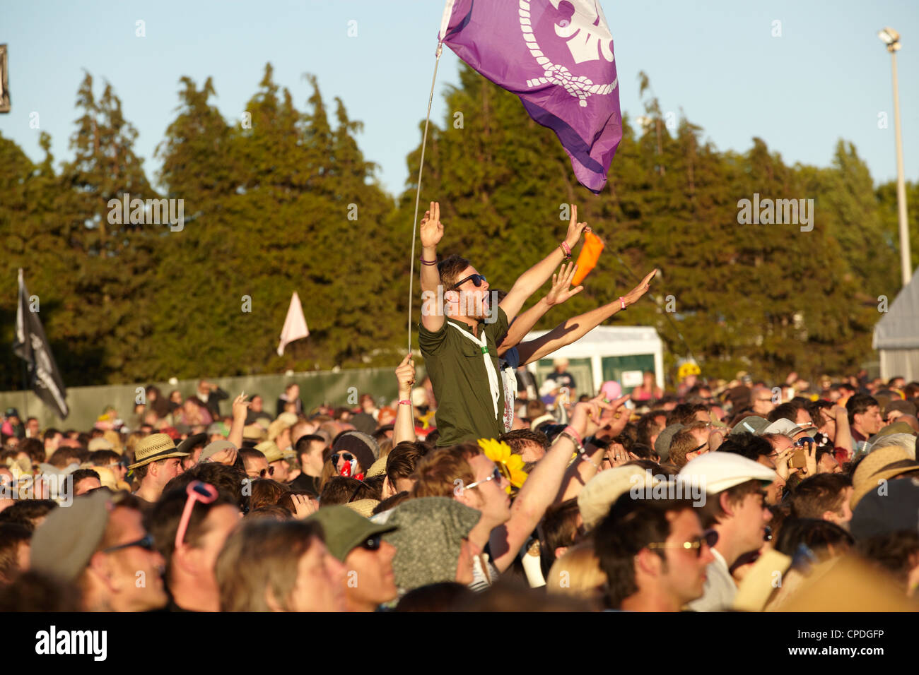 Boy in crowd on shoulders screaming and cheering at a music festival ...