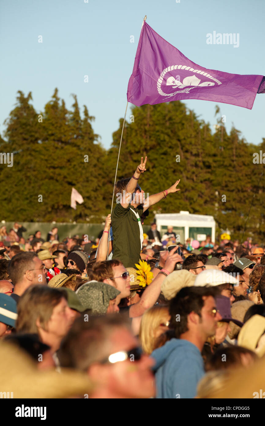 Boy in crowd on shoulders screaming and cheering at a music festival ...