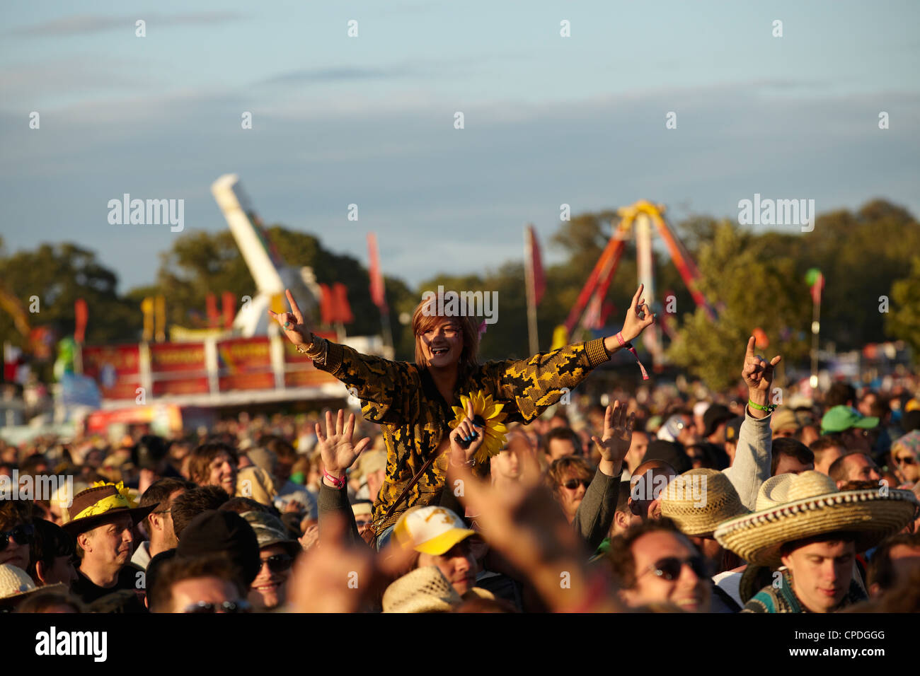 Girl in crowd on shoulders screaming and cheering at a music festival ...