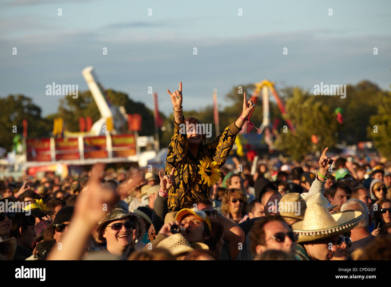 Girl in crowd on shoulders screaming and cheering at a music festival ...