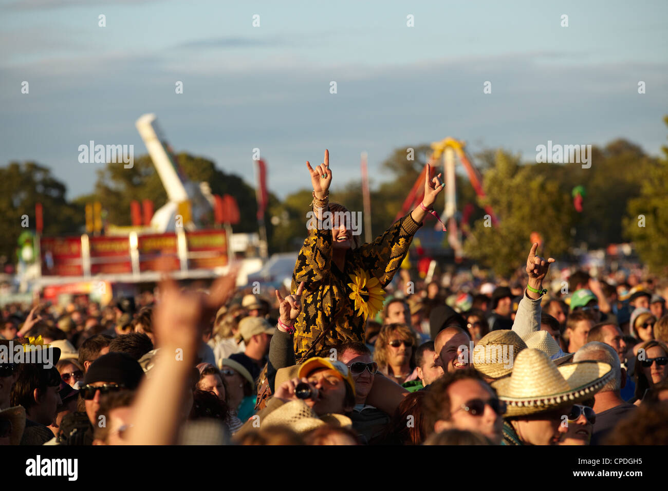 Girl in crowd on shoulders screaming and cheering at a music festival ...