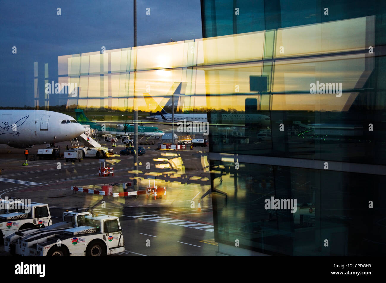 Dublin Airport with reflections through terminal windows early morning ...
