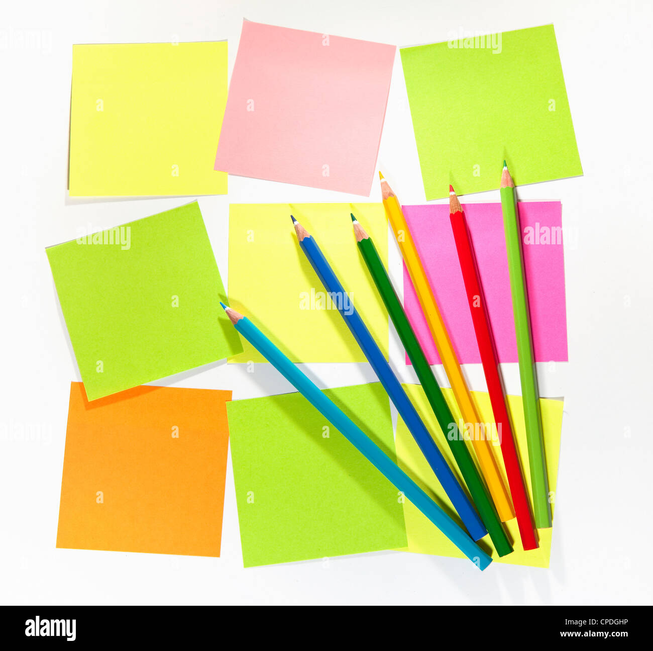 Colour pencils on the postit for reminder note Stock Photo - Alamy