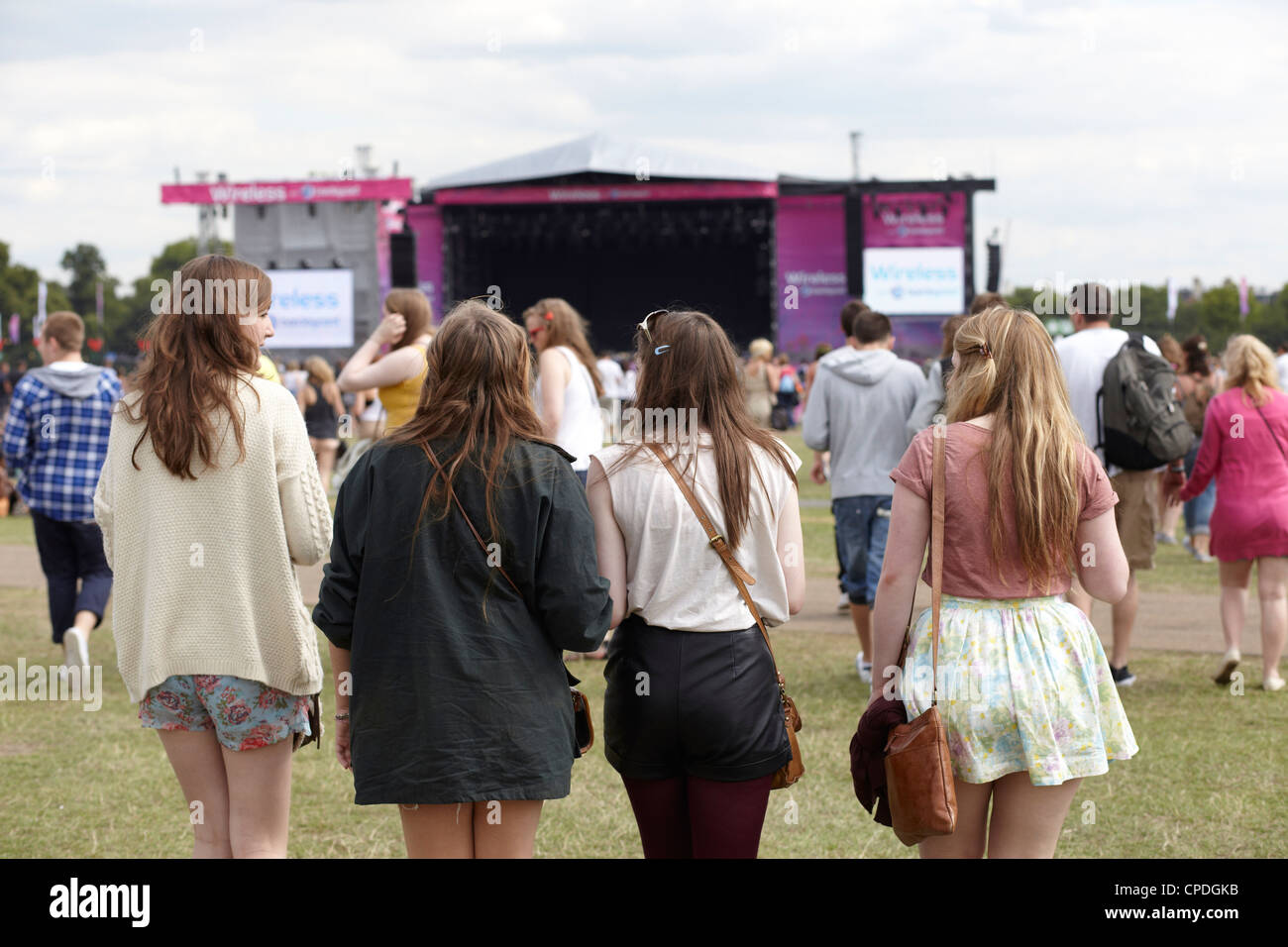 Girls walking to mains stage a a music festival Stock Photo - Alamy
