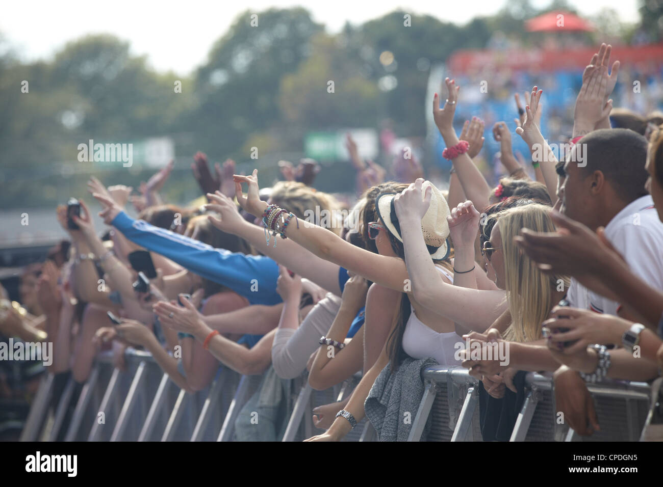 Front row crowd cheering hands in the air clapping Stock Photo - Alamy