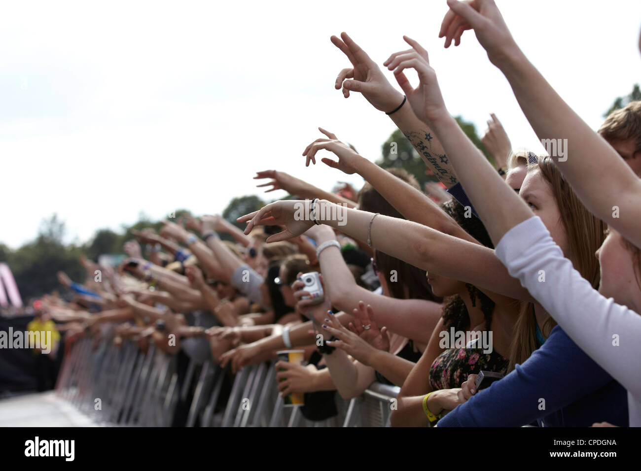 Front row crowd cheering hands in the air clapping Stock Photo - Alamy