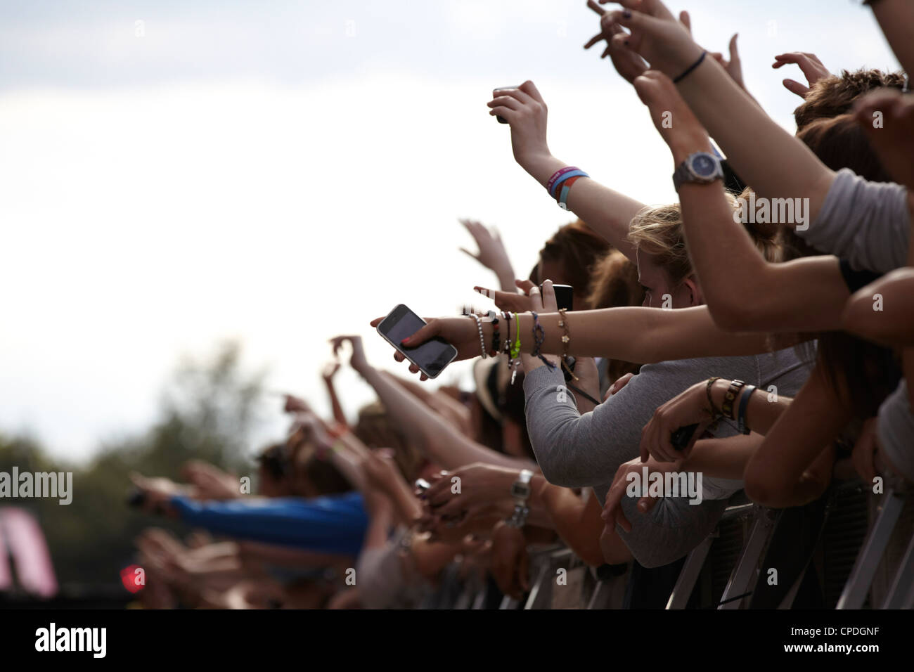 Front row crowd cheering hands in the air clapping Stock Photo - Alamy