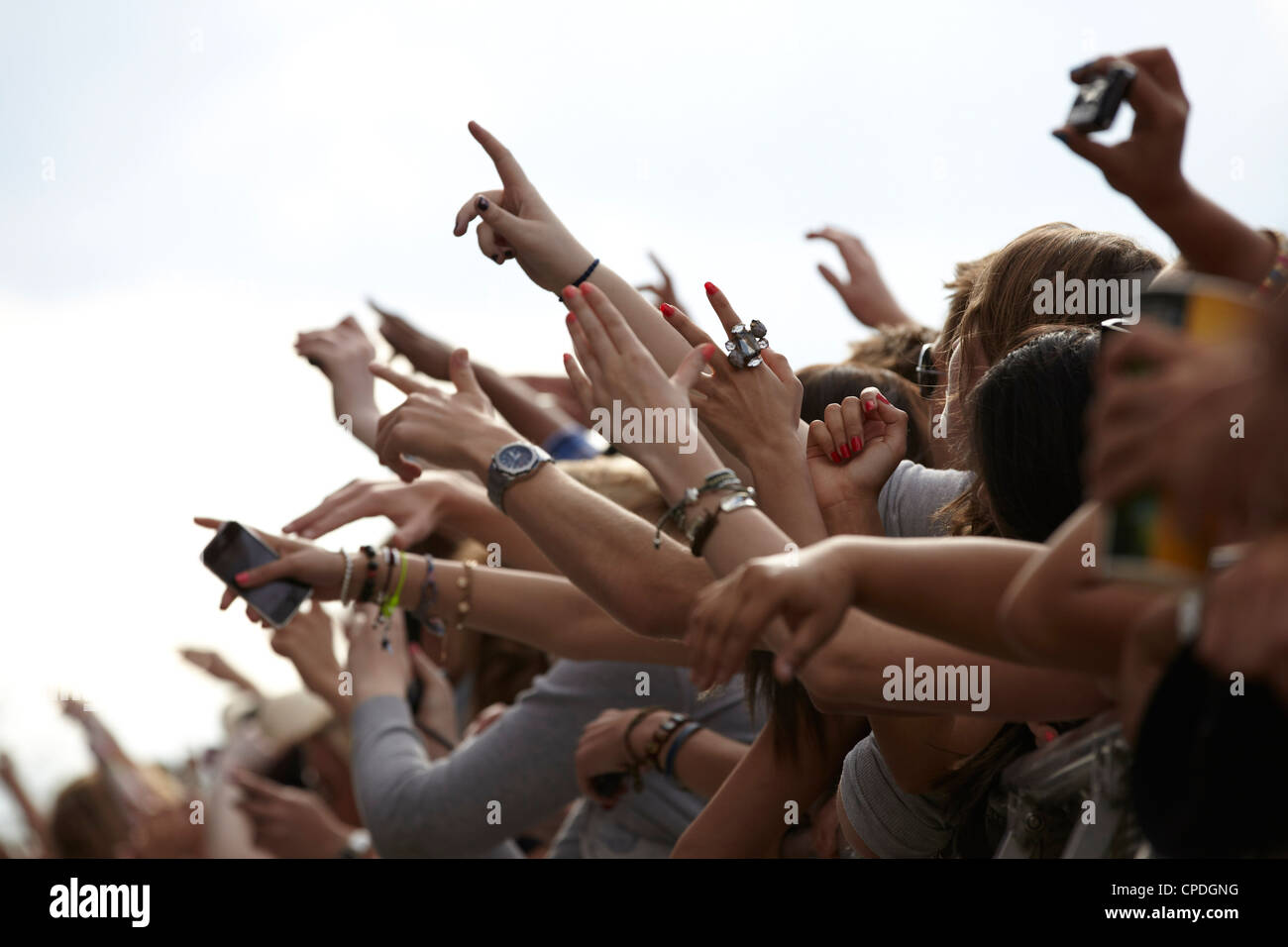 Front row crowd cheering hands in the air clapping Stock Photo - Alamy