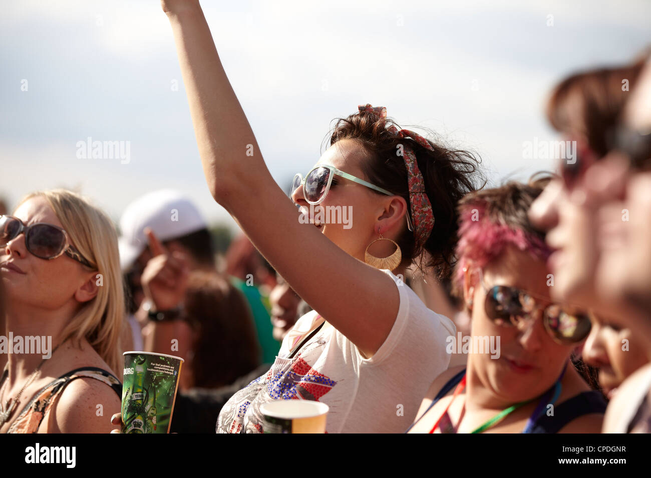 Girl cheering in a crowd at music festival Stock Photo - Alamy