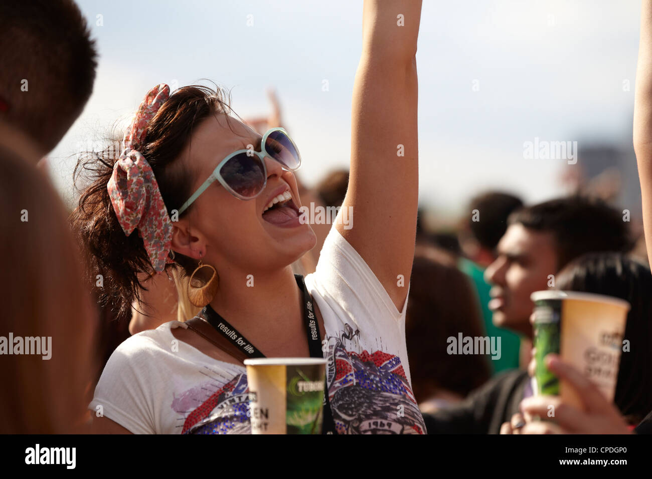 Girl cheering in a crowd at music festival Stock Photo - Alamy