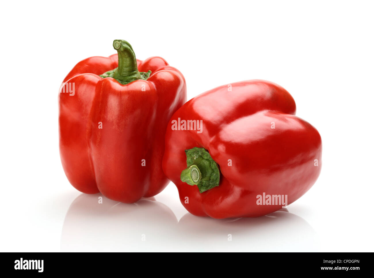 Two red Bell peppers on white background Stock Photo - Alamy