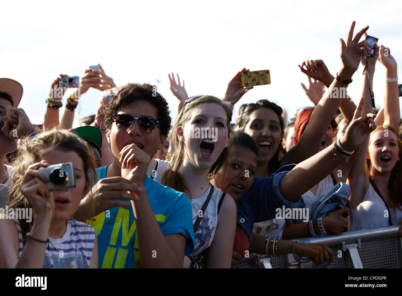 Crowd in the front row at front of the stage at a music festival in the ...
