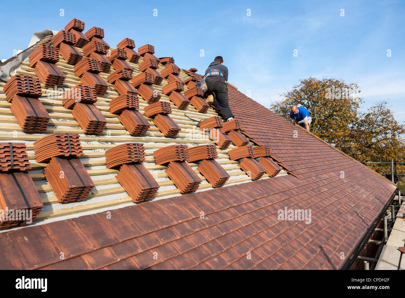 Detached house having tiles striped from roof and replacing with new ...