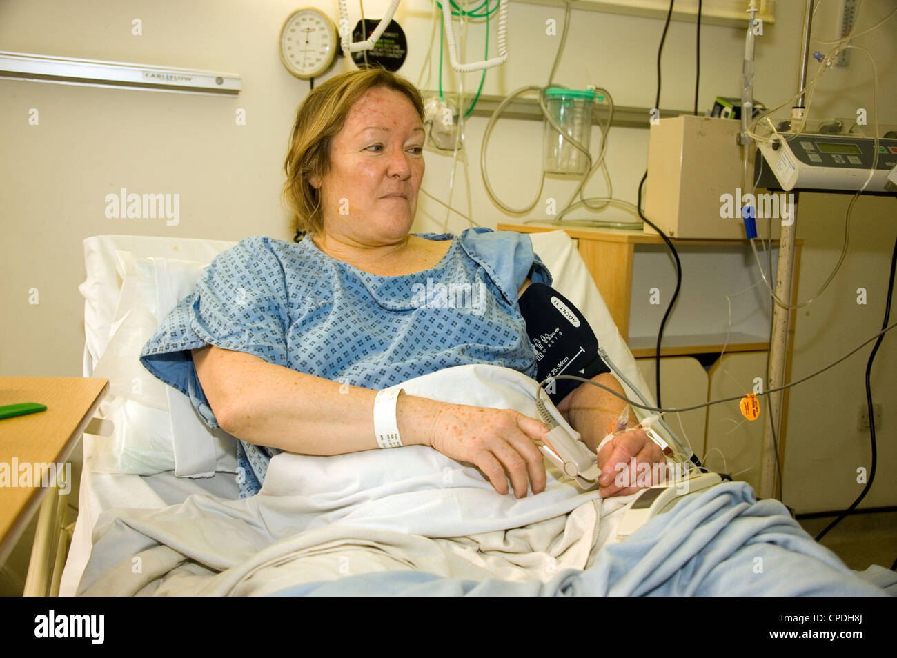 A middle aged woman in a post operation room being monitored Stock ...