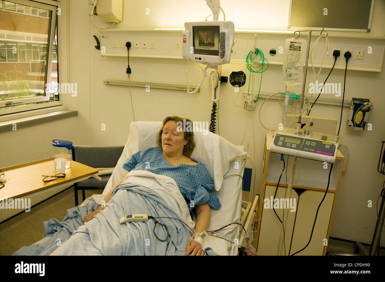 A middle aged woman in a post operation room shortly after her ...