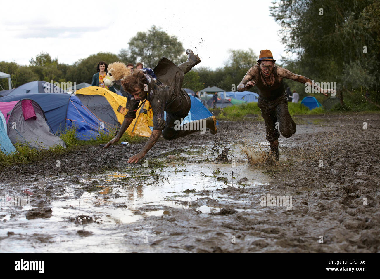 Boys playing in mud at music festival in the UK Stock Photo - Alamy