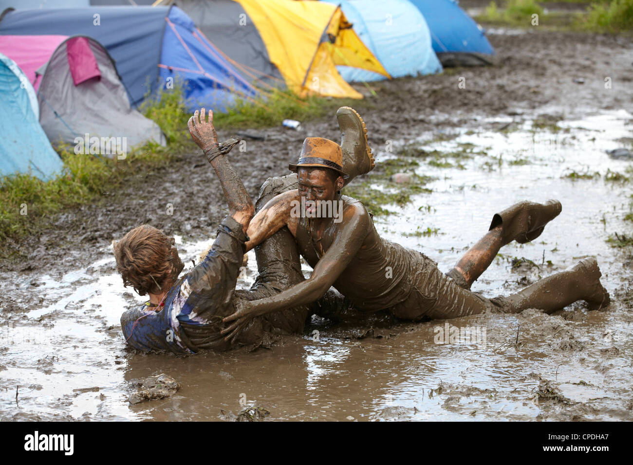 Boys playing in mud at music festival in the UK Stock Photo - Alamy