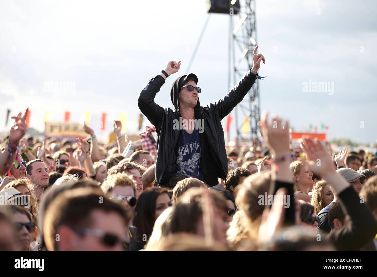Boy at music festival cheering in a crowd on shoulders Stock Photo - Alamy