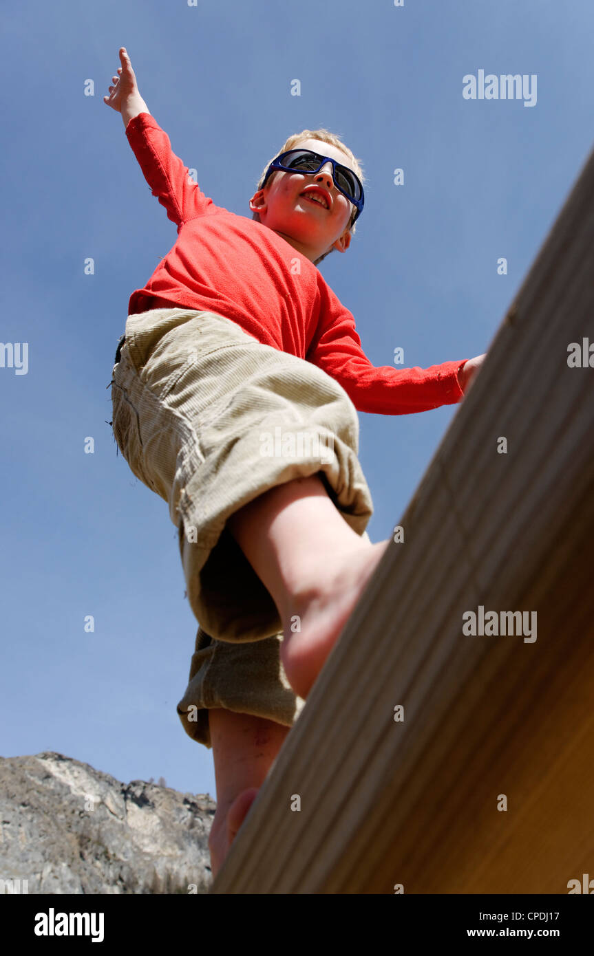 A young boy on a balance beam Stock Photo - Alamy