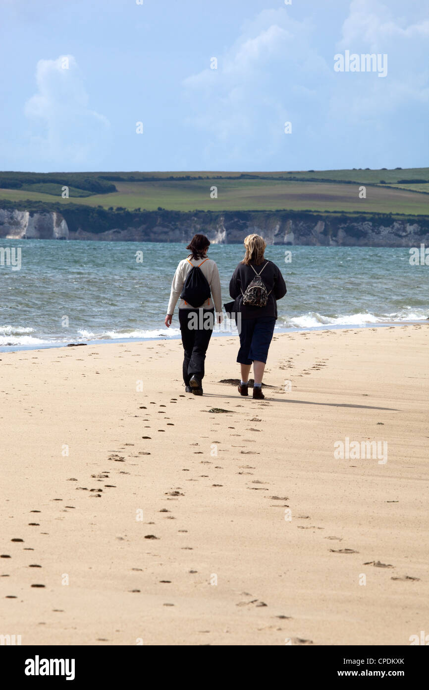 Walkers on the beach at Studland Stock Photo - Alamy