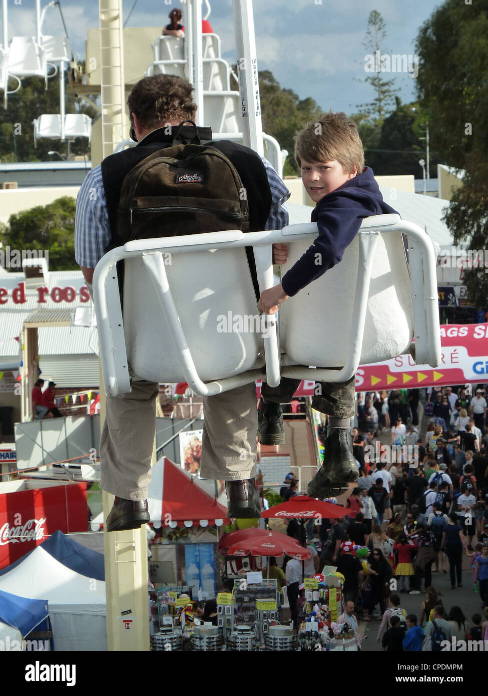 Father and son on chair lift at fair Stock Photo - Alamy