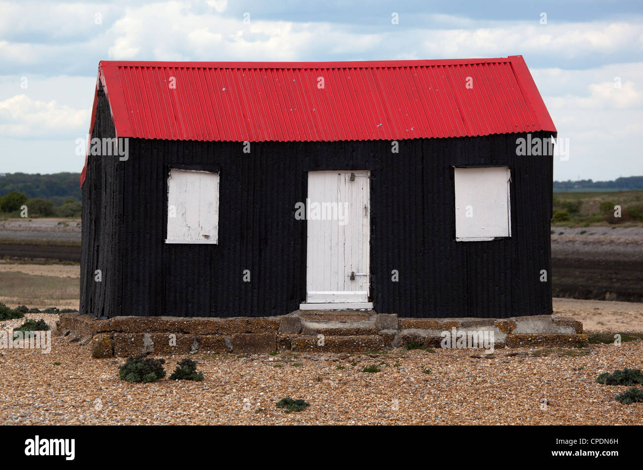 Black Hut with Red Roof Stock Photo - Alamy