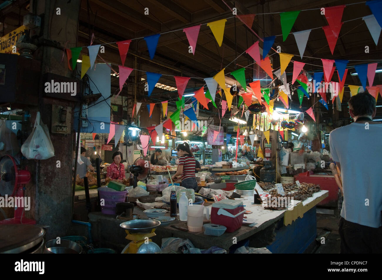 Coloured flags hanging at a stall in a market in Thailand Stock Photo ...