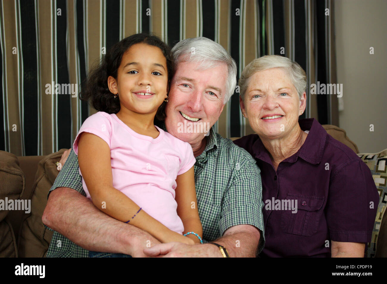 Grandparents together with their family at home Stock Photo - Alamy
