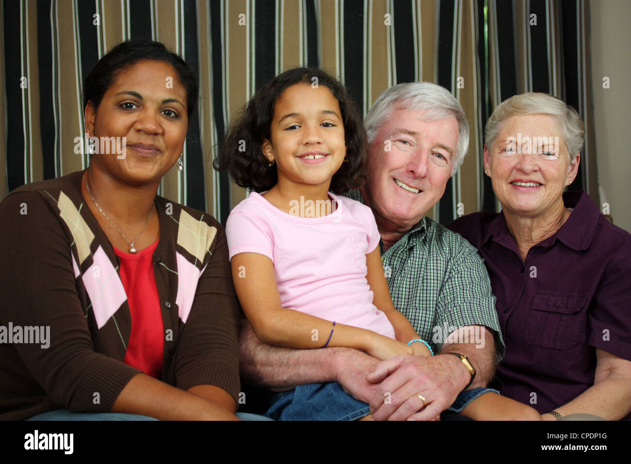 Grandparents together with their family at home Stock Photo - Alamy