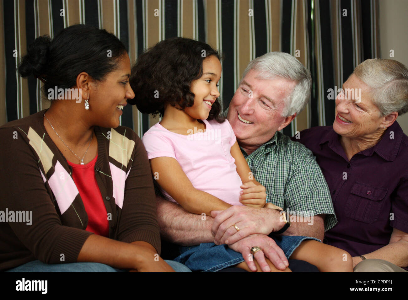 Grandparents together with their family at home Stock Photo - Alamy