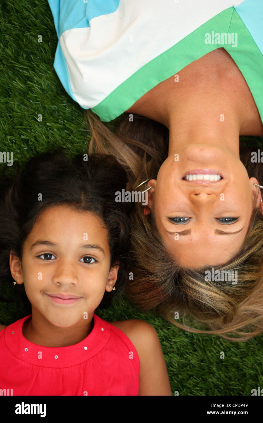 Family Laying Together Outside In The Grass Stock Photo - Alamy